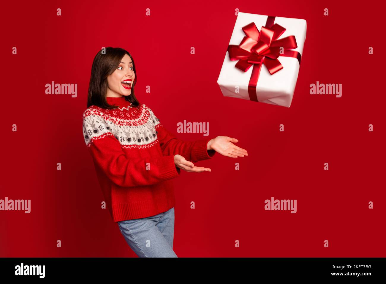 Photo of astonished cheerful girl arms catch falling newyear giftbox ...