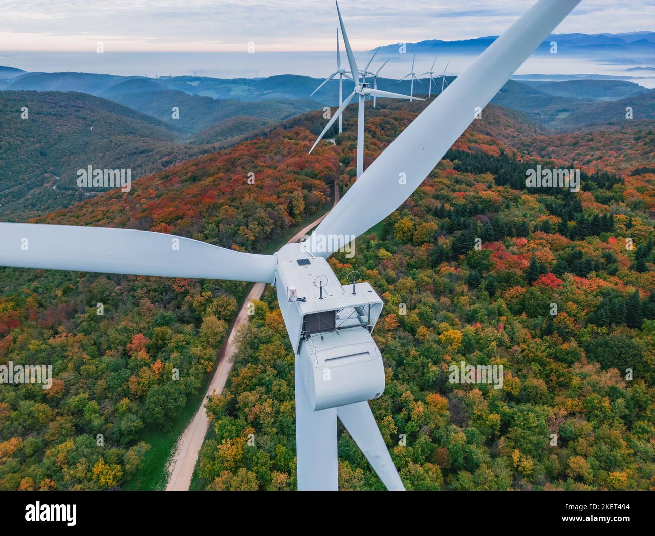 Close-up on the propellers of a wind turbine during a misty morning and ...