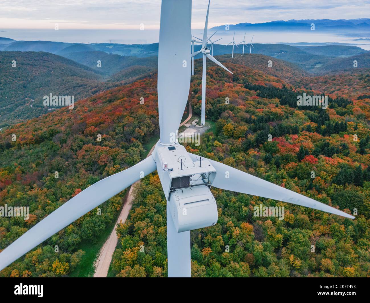 Close-up on the propellers of a wind turbine during a misty morning and ...