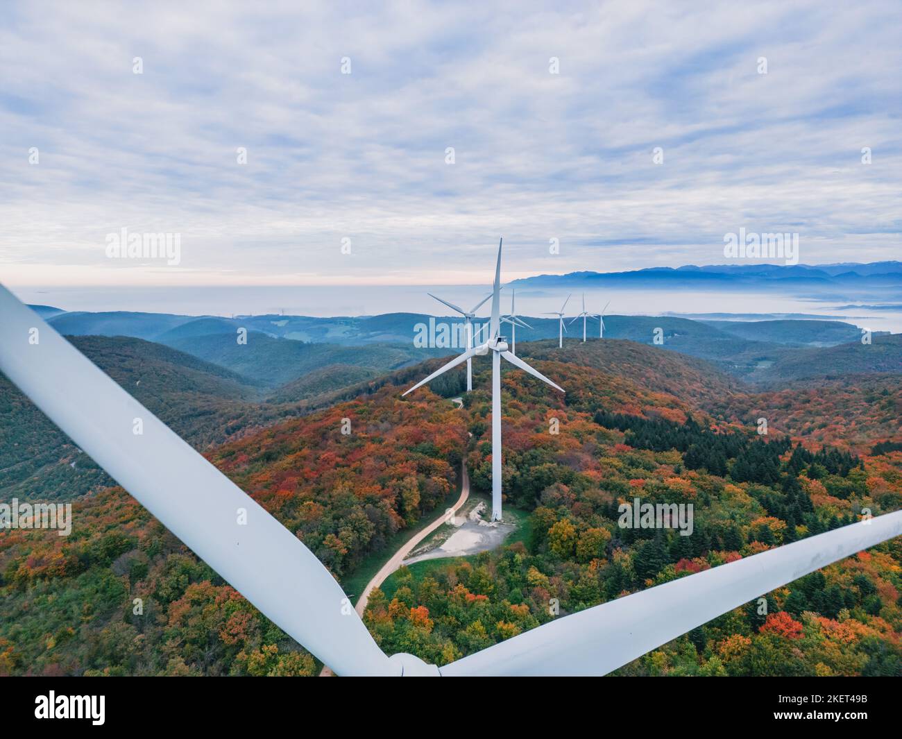 Close-up on the propellers of a wind turbine during a misty morning and ...