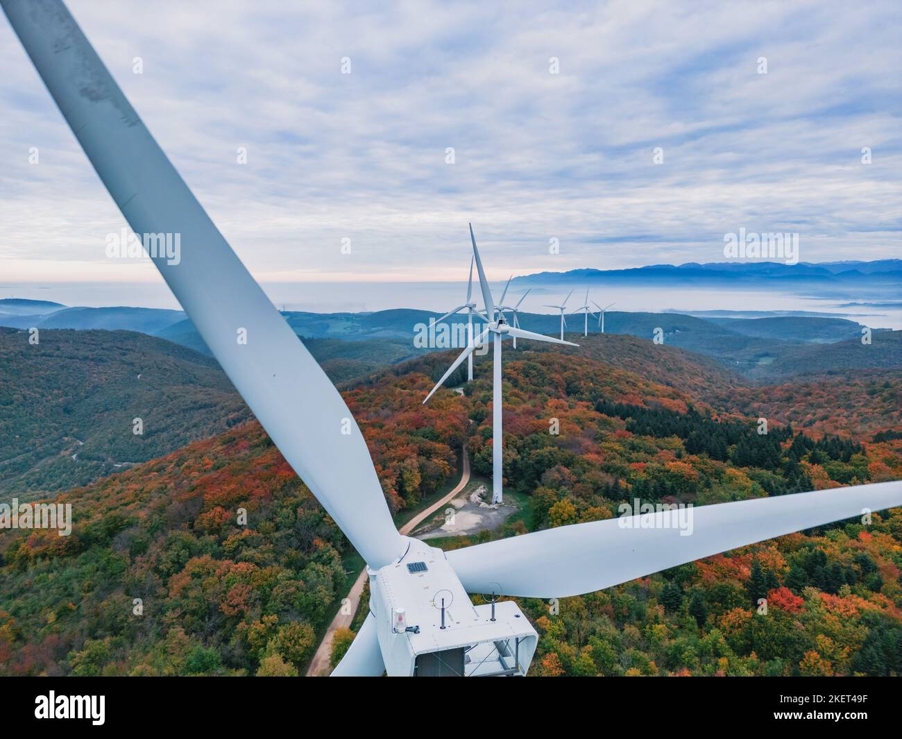 Close-up on the propellers of a wind turbine during a misty morning and ...