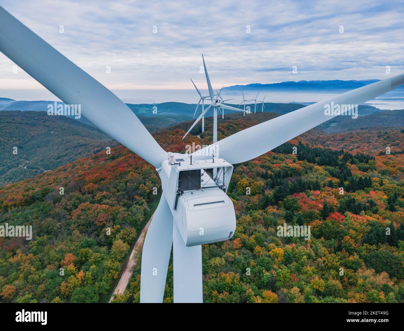 Close-up on the propellers of a wind turbine during a misty morning and ...