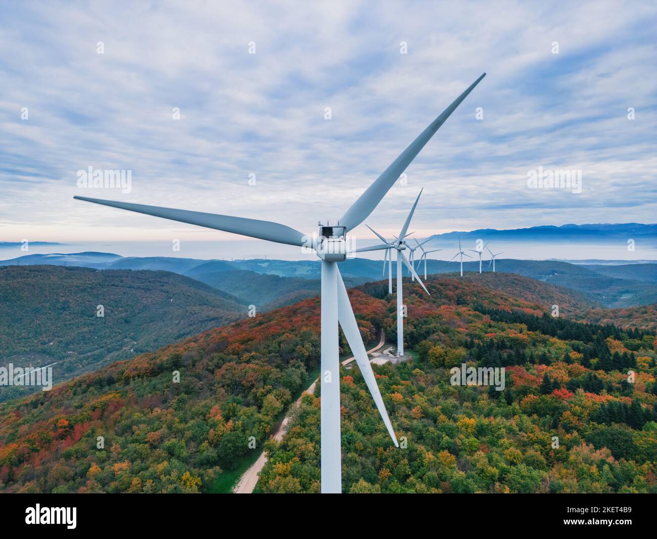 Close-up on the propellers of a wind turbine during a misty morning and ...