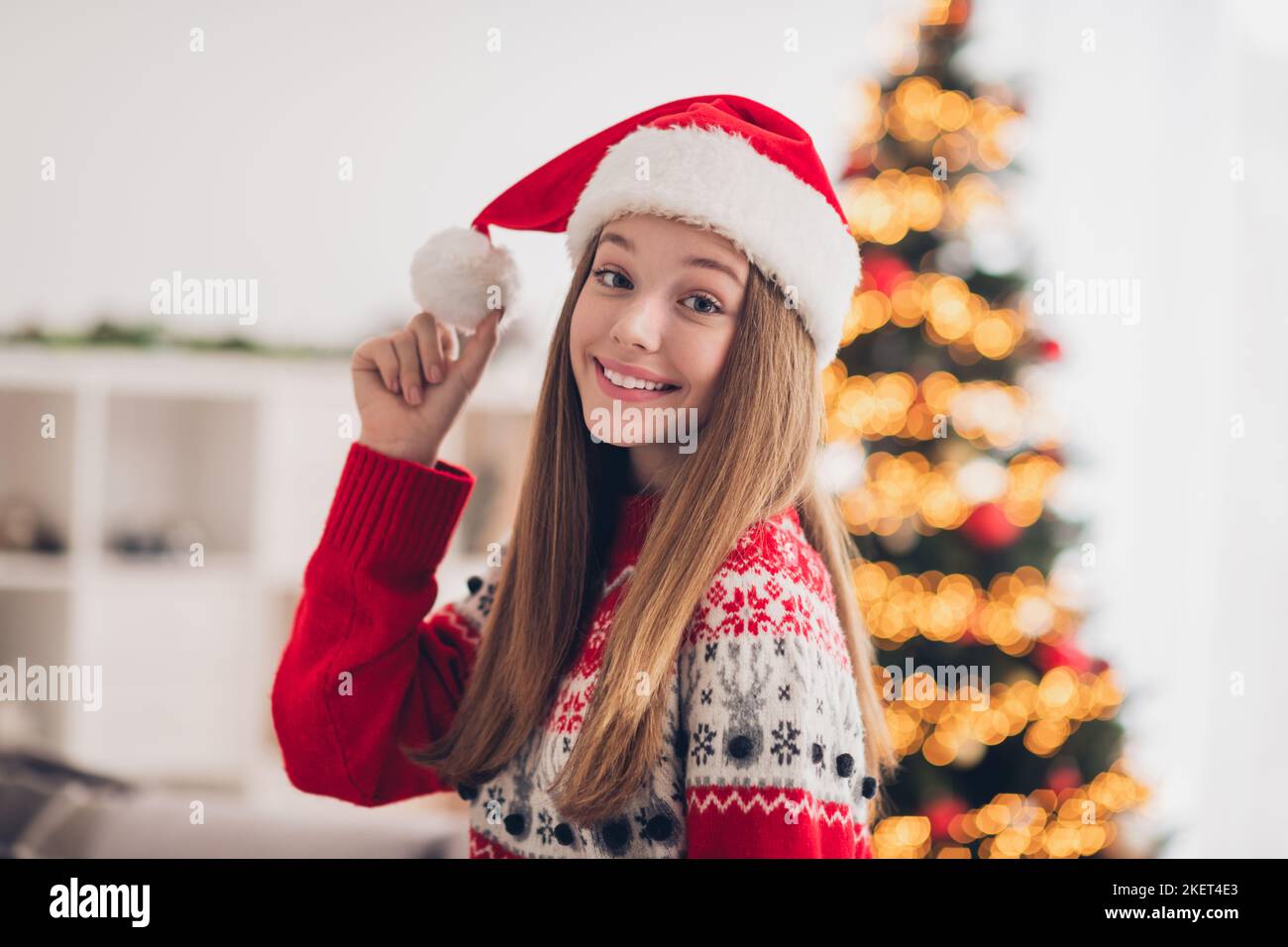 Photo of lovely cheerful girl toothy smile hand touch newyear hat ...