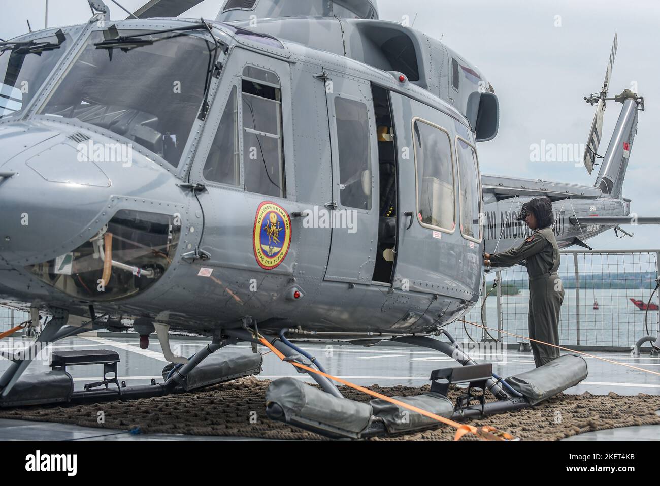 A member of the Indonesian Navy Aviator checks a helicopter that docks ...