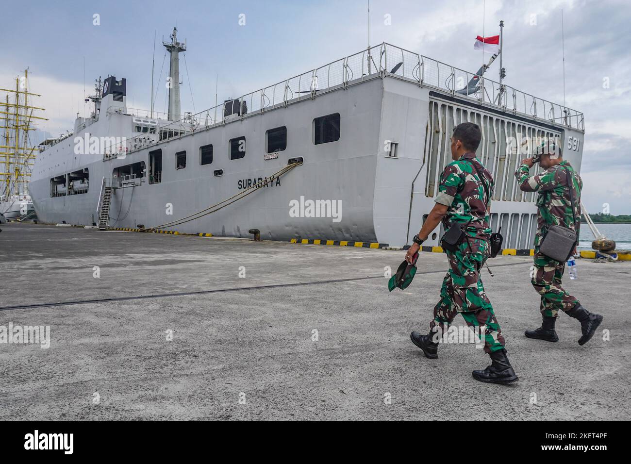 Two military member walk across the Indonesian Navy Ship KRI Surabaya ...