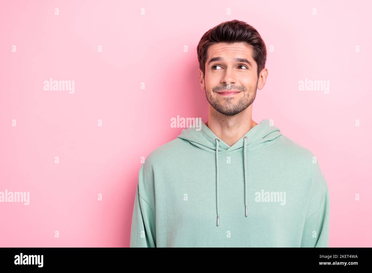 Portrait photo of cute positive nice guy looking shy empty space minded ...