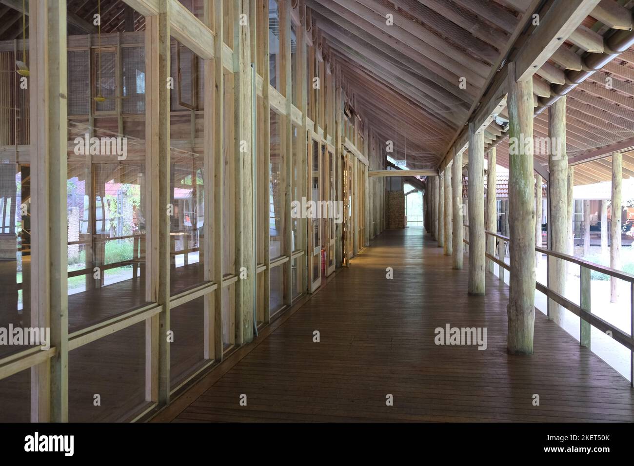 A wooden made hall with a spacious social area and corridor at Janda ...
