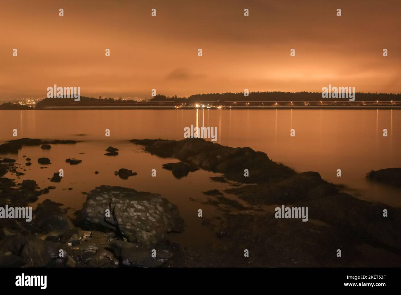 sunrise over calm water - Lysaker Stock Photo - Alamy