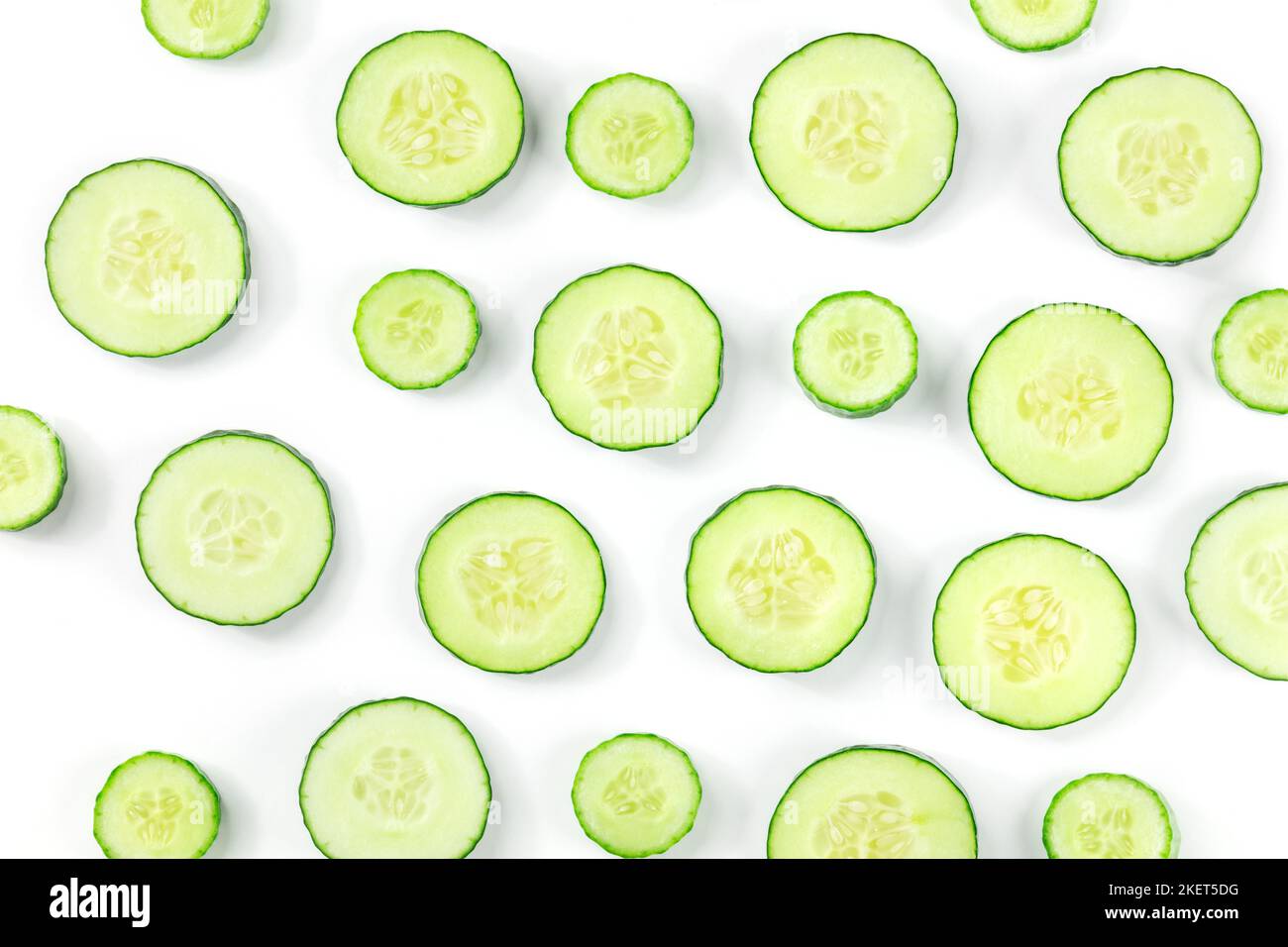 Fresh cucumber slices on a white background, overhead flat lay shot ...