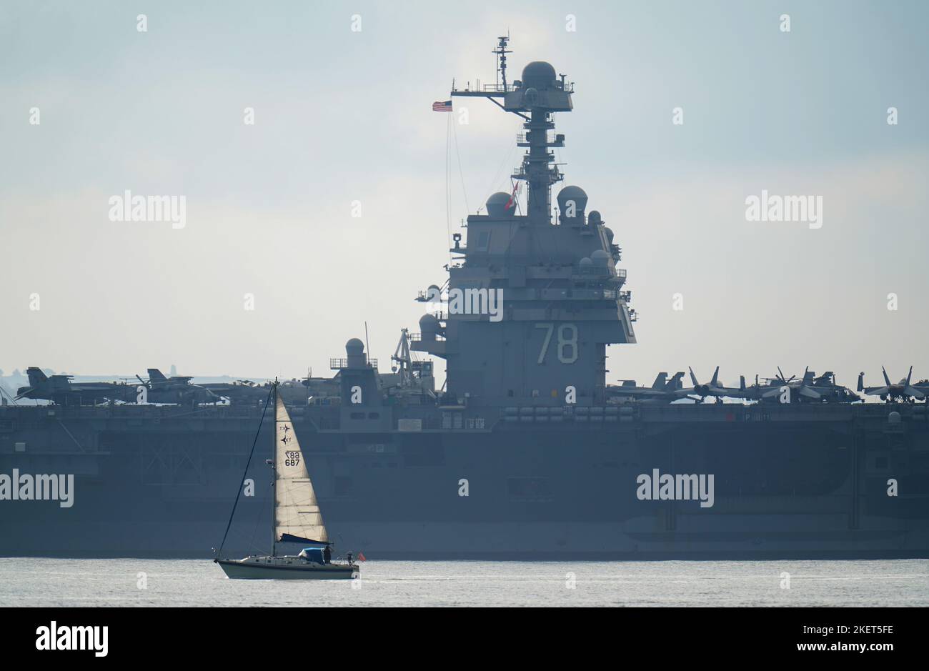 A sailing boat makes it's way past the USS Gerald R. Ford as it makes ...