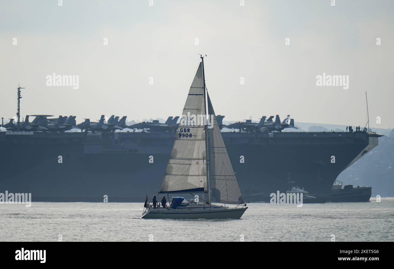 A sailing boat makes it's way past the USS Gerald R. Ford as it makes ...