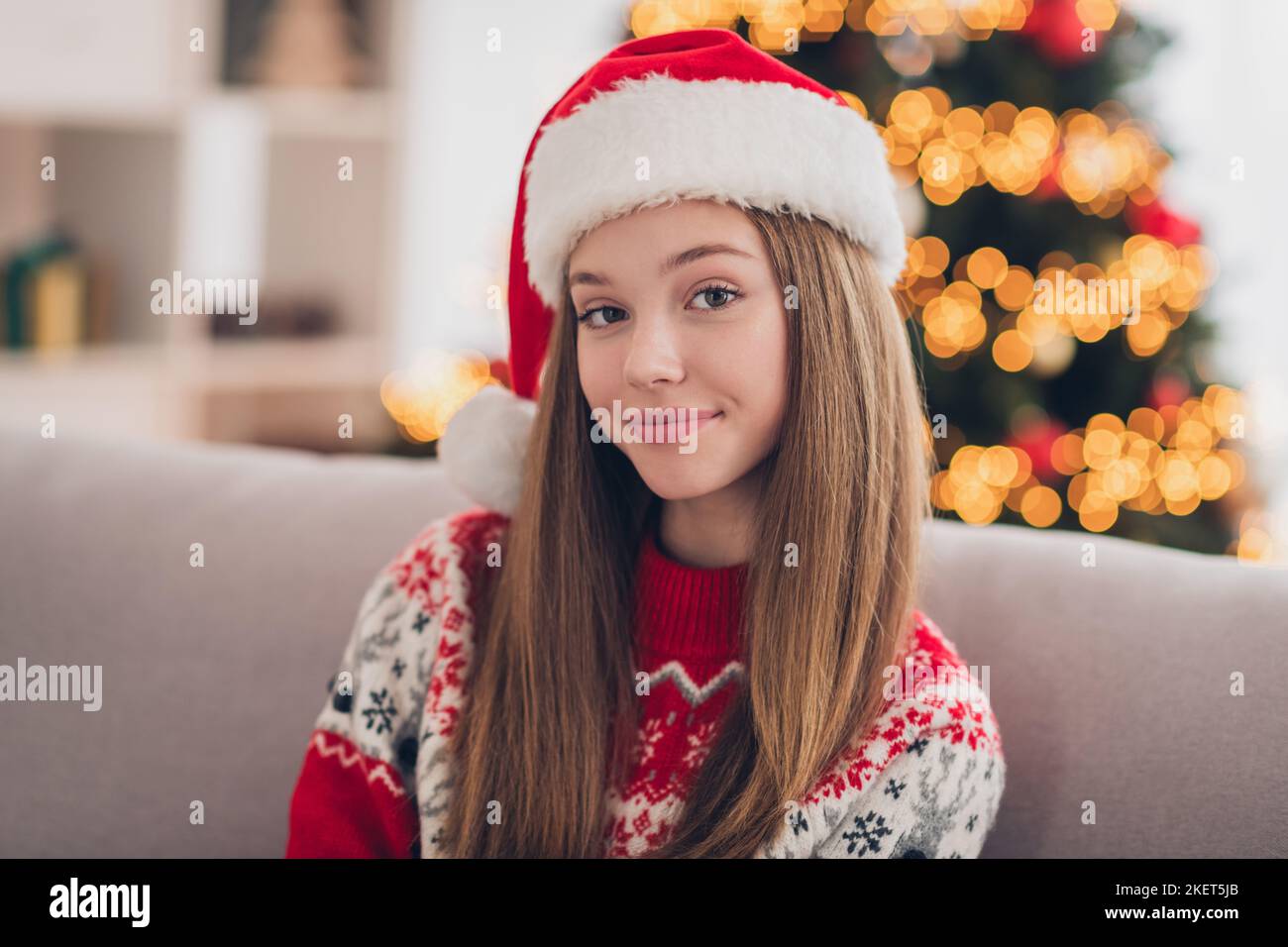 Photo of sweet positive girl sitting couch festive headwear spent ...