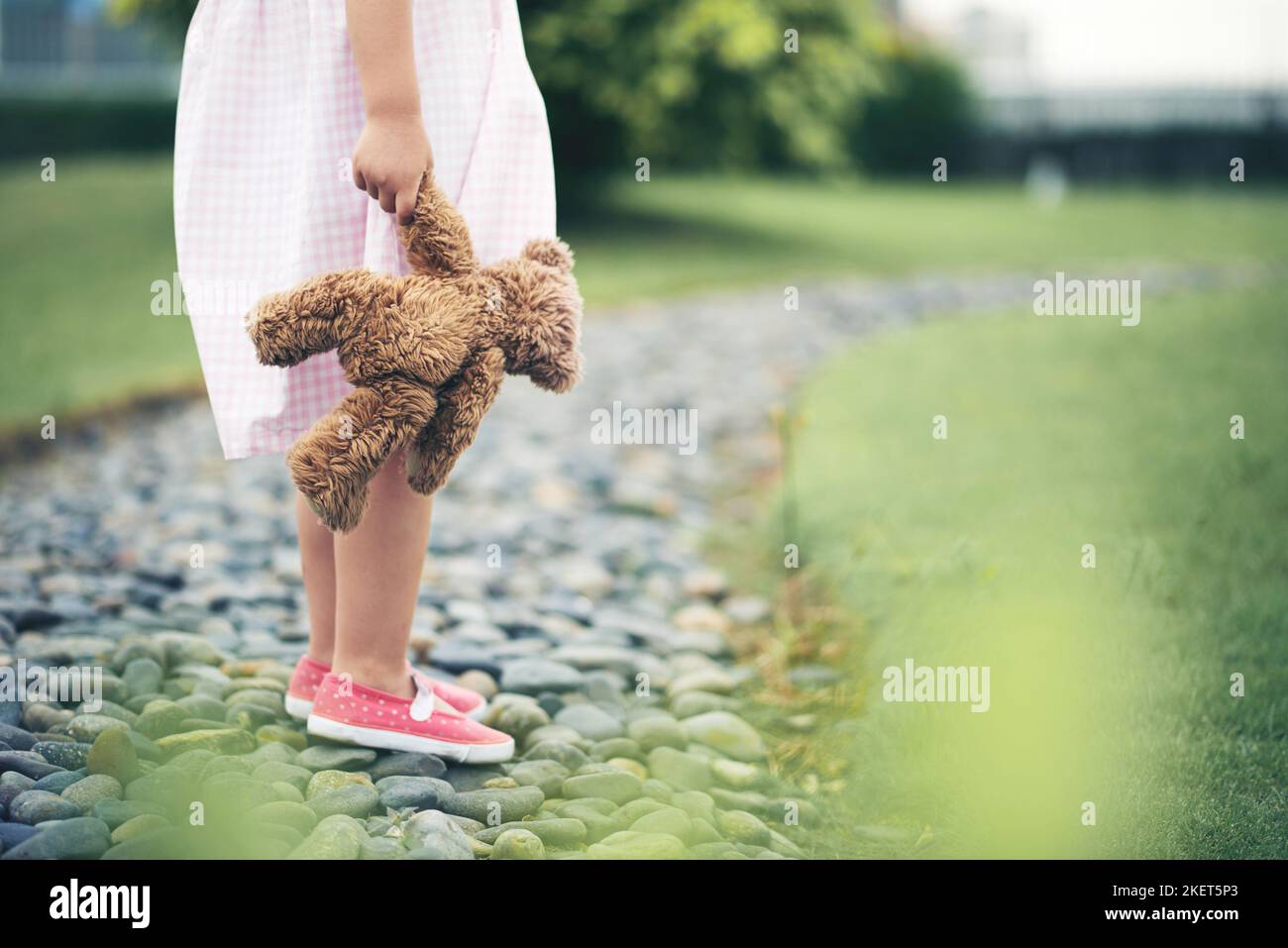 Cropped image of little girl standing outdoors with teddy bear Stock ...