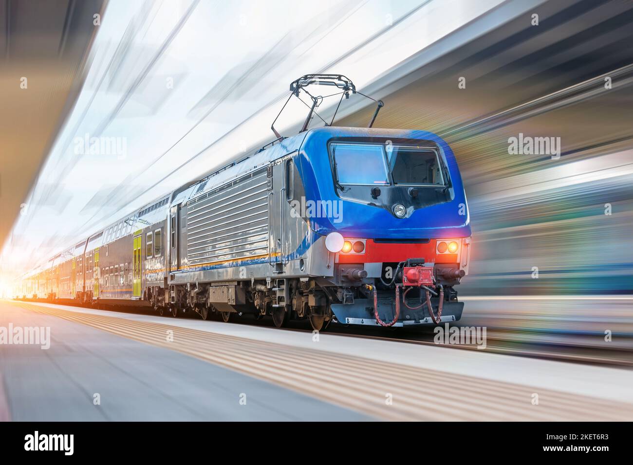 Railway station with head locomotive high speed commuter train with ...