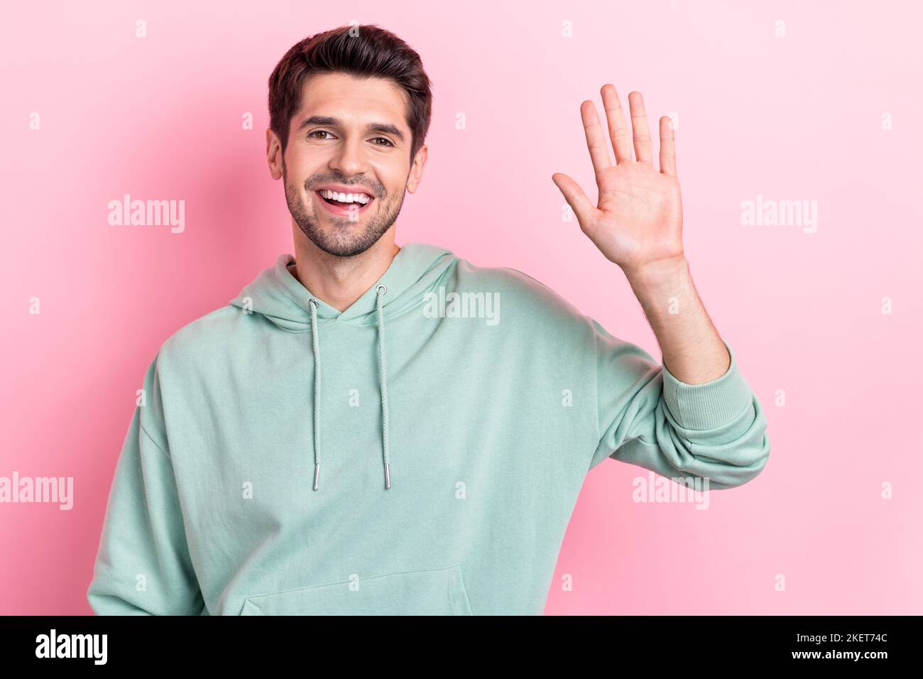 Portrait of satisfied glad person beaming smile arm palm waving hello ...