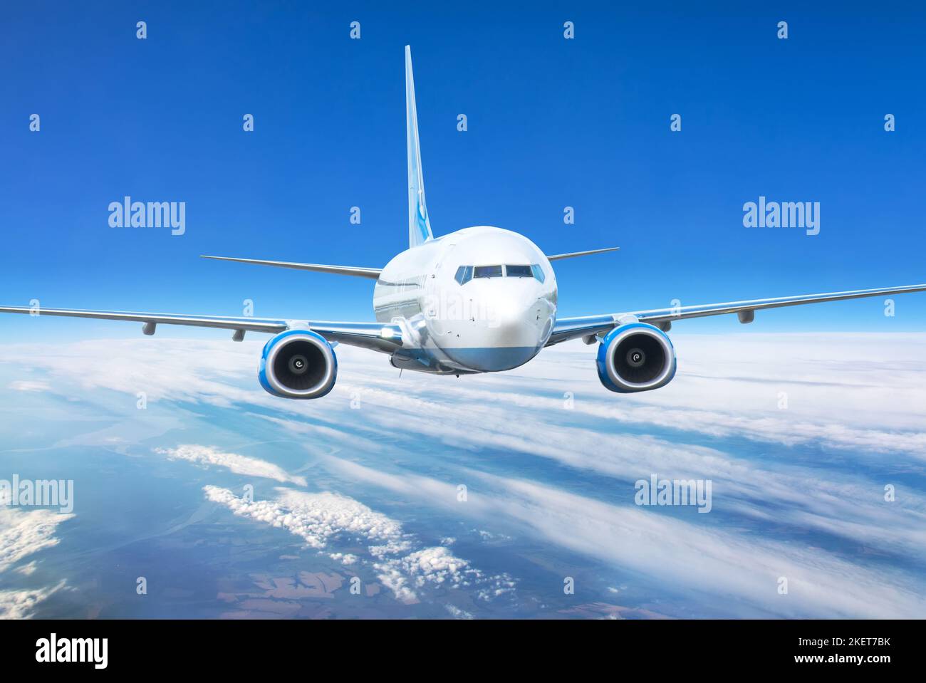 Close up view airplane in flight. Passenger jet plane in the blue sky ...