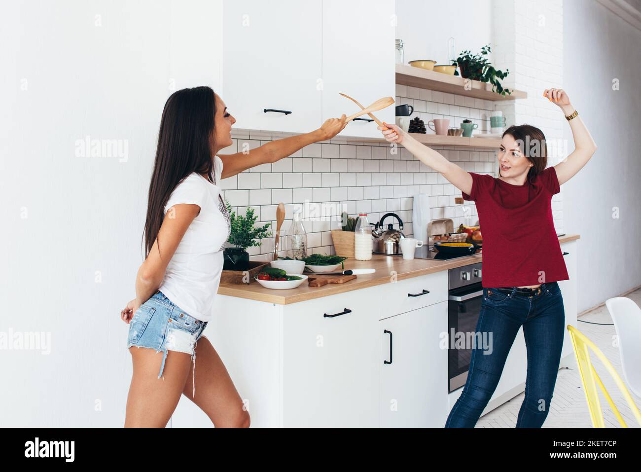 Two woman image that they are fighting on swords by wooden spatulas in ...