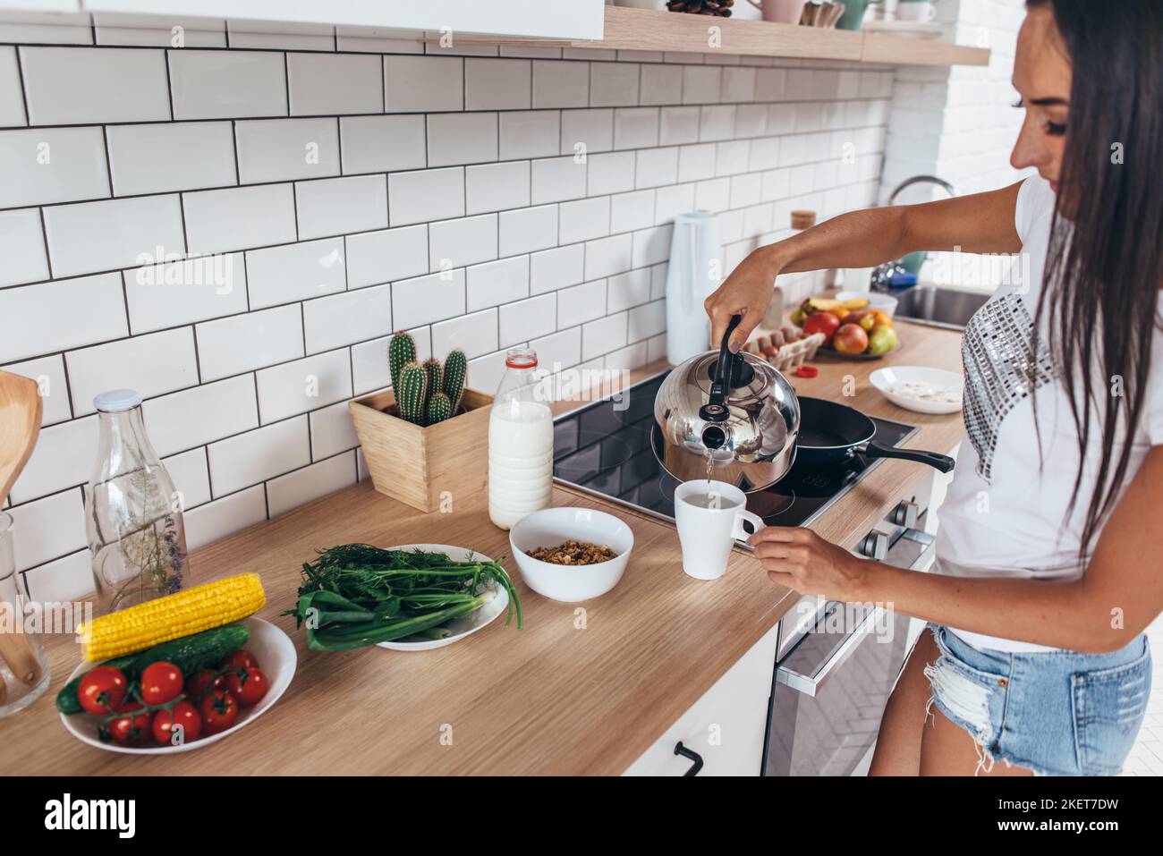 Woman pouring boiling water into a cup from kettle Stock Photo - Alamy Woman pouring boiling water into a cup from kettle Stock Photo - Alamy