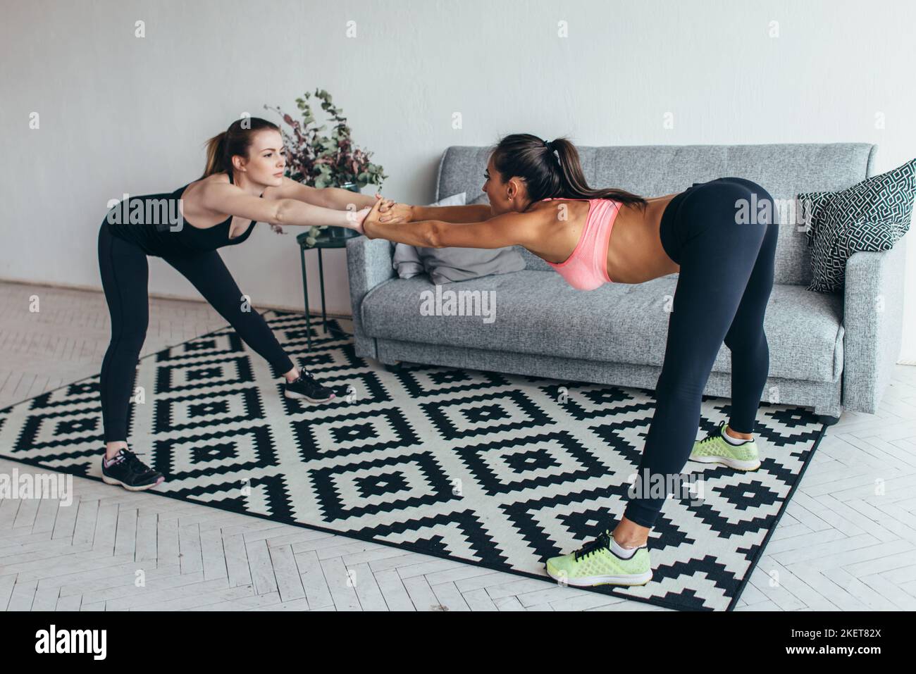 Stretch fitness women doing stretching exercise together. Standing ...