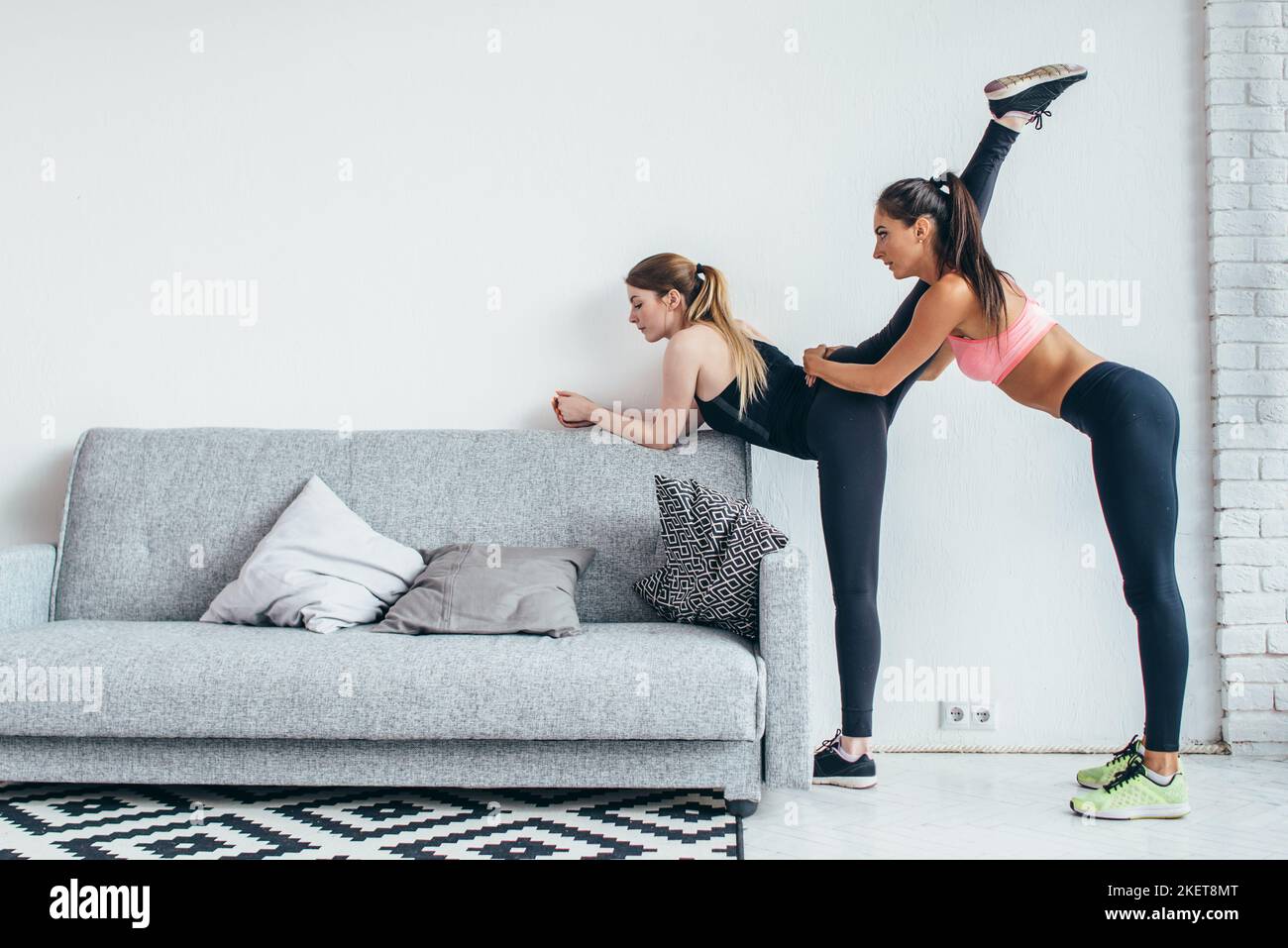 Fit girls preparing legs workout. Leg stretching exercise fitness woman ...