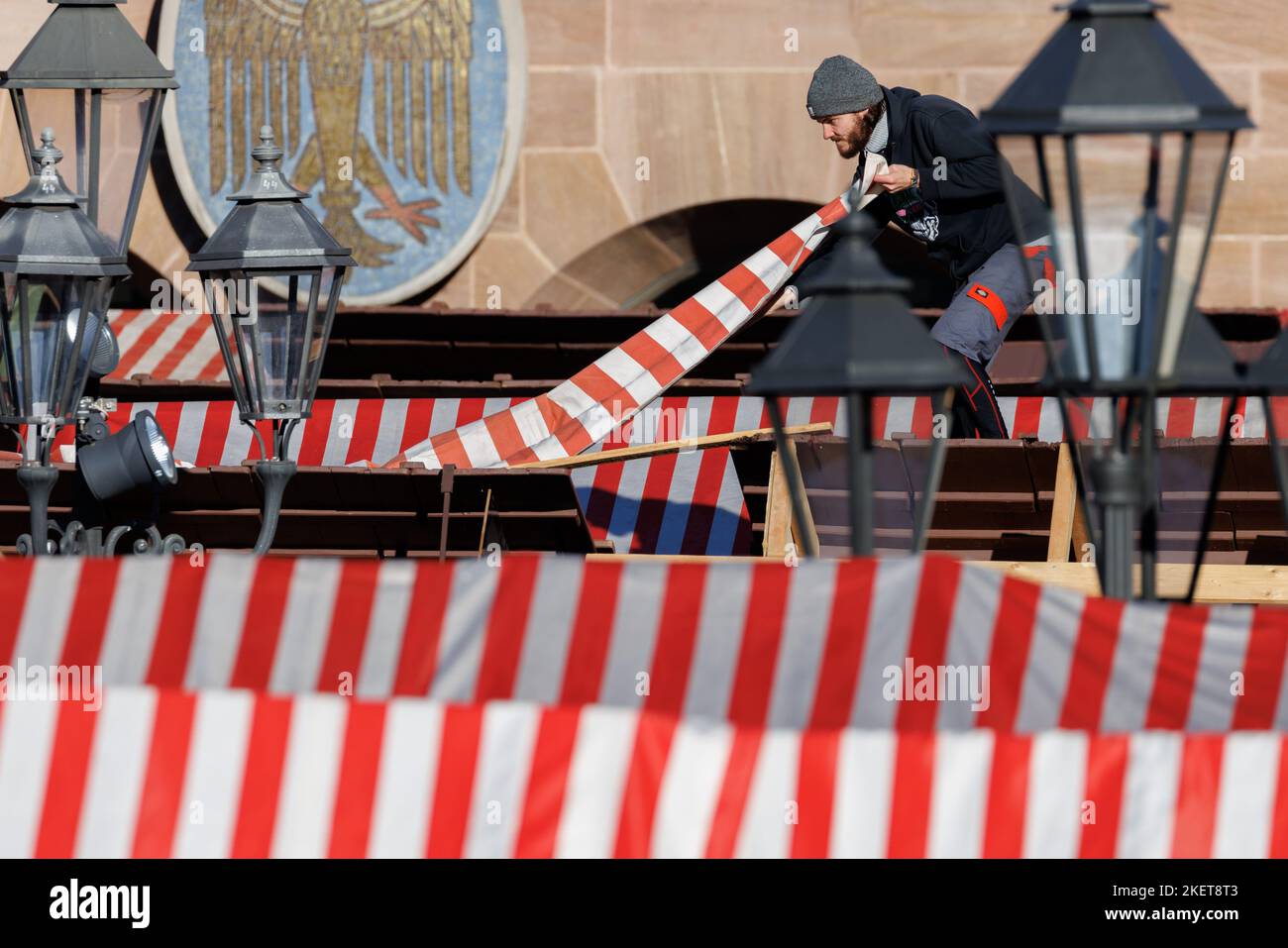 Nuremberg, Germany. 14th Nov, 2022. A stand operator places the red and ...