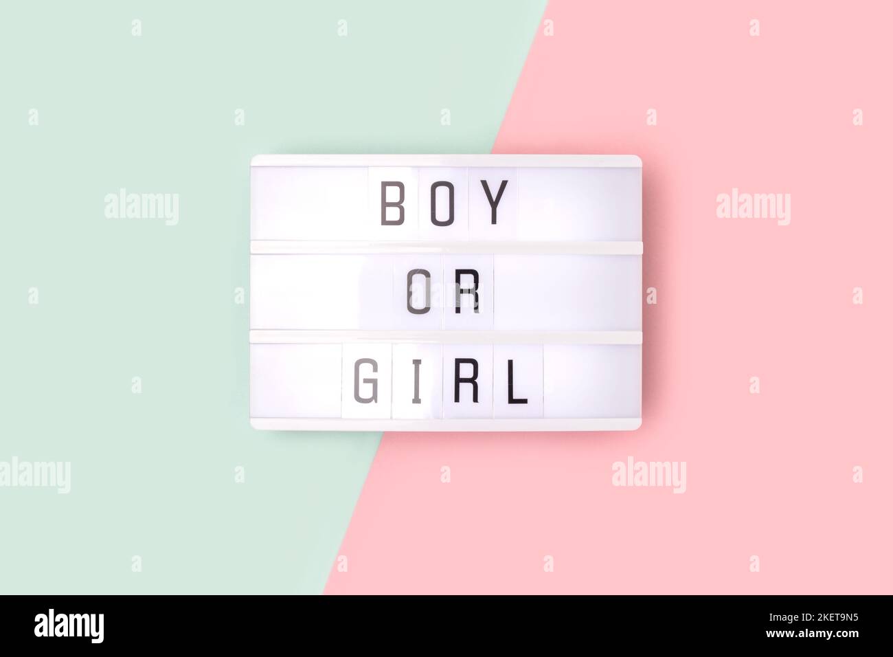 Boy or girl. Lightbox with letters on a pink and blue background. Baby ...