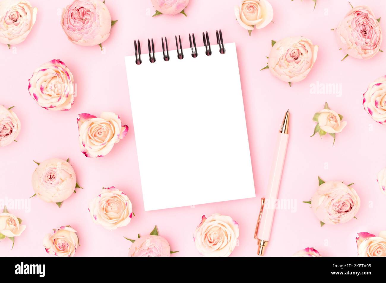 Empty notepad mockup. Stationery and rose flowers on a pink pastel ...