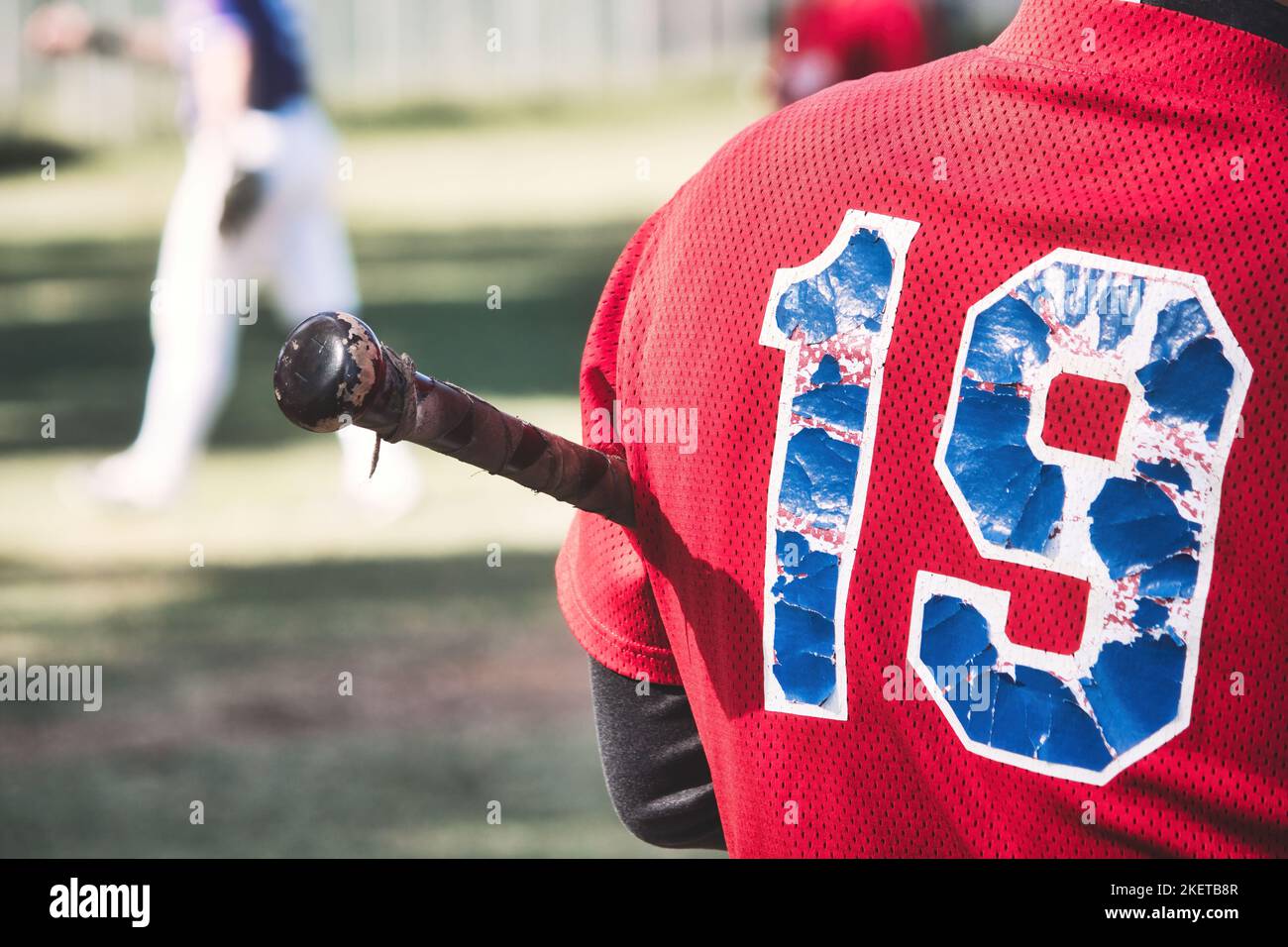 Close-up of the back of a baseball player holding a bat with the number ...