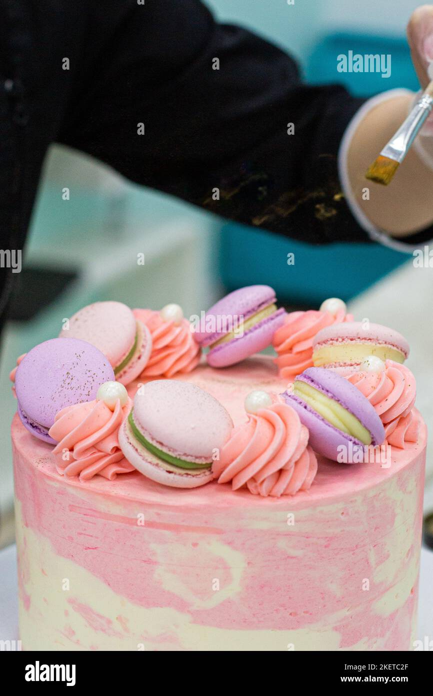 Pastry chef in the kitchen decorating a cake Stock Photo - Alamy
