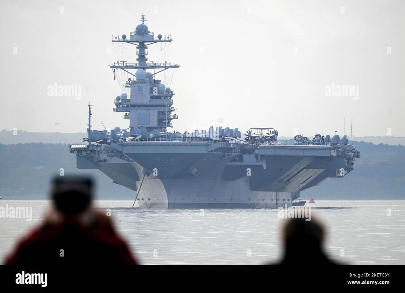 People look out as the USS Gerald R. Ford whilst at anchor in Stokes ...