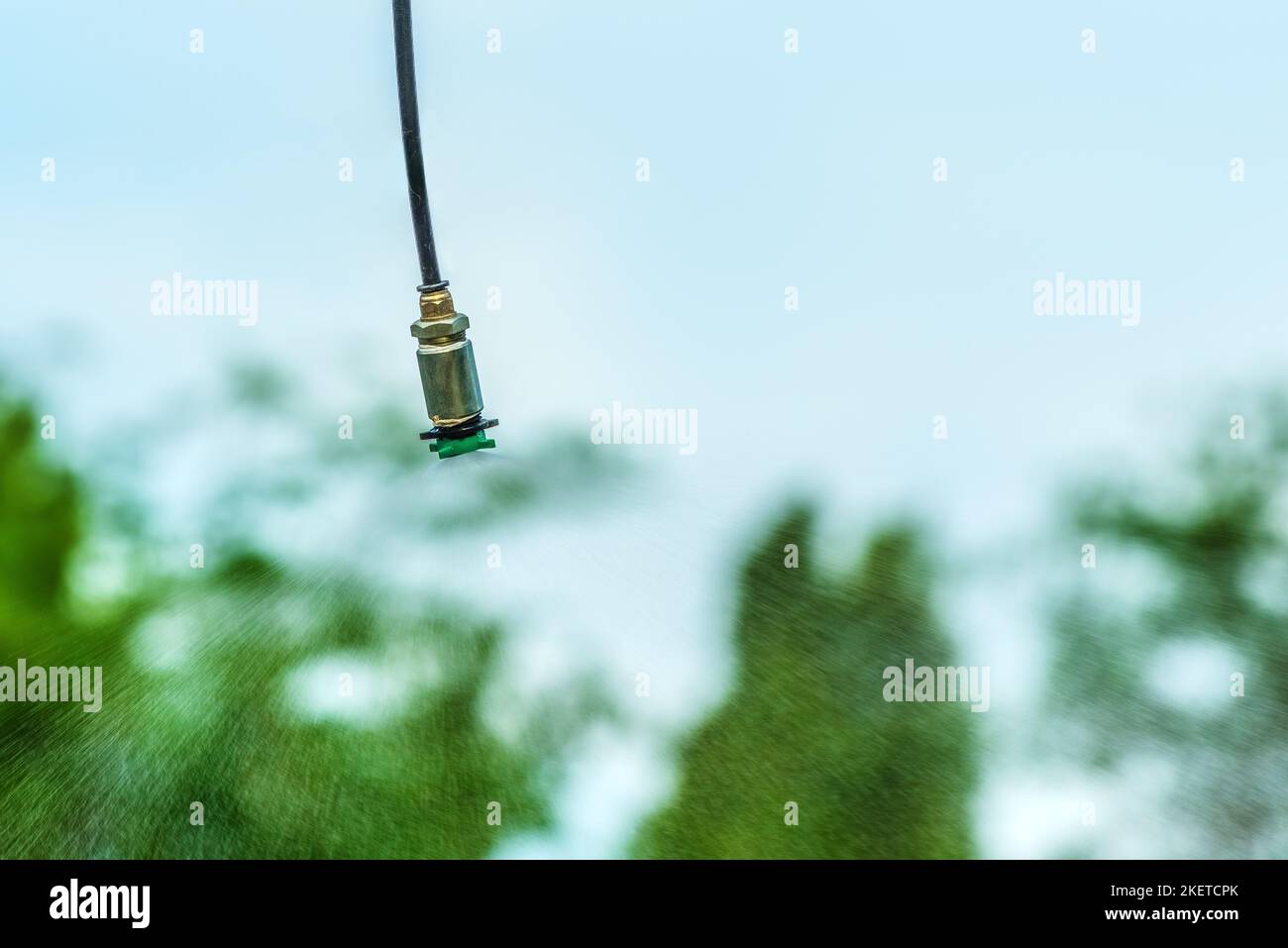 Agricultural sprinkler spraying the water drops over crops in ...