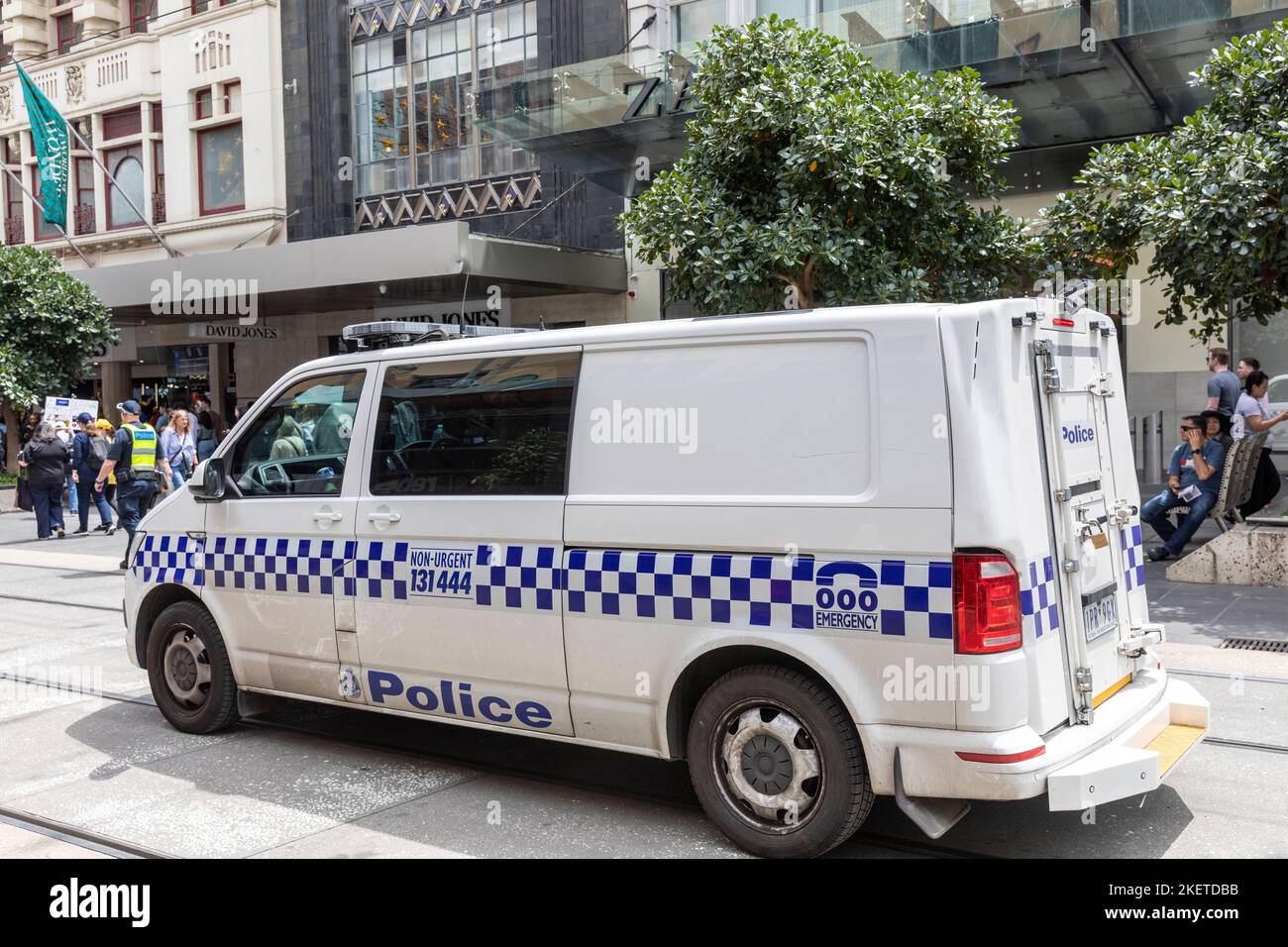 Victorian police in Melbourne city centre police officer walks in front ...