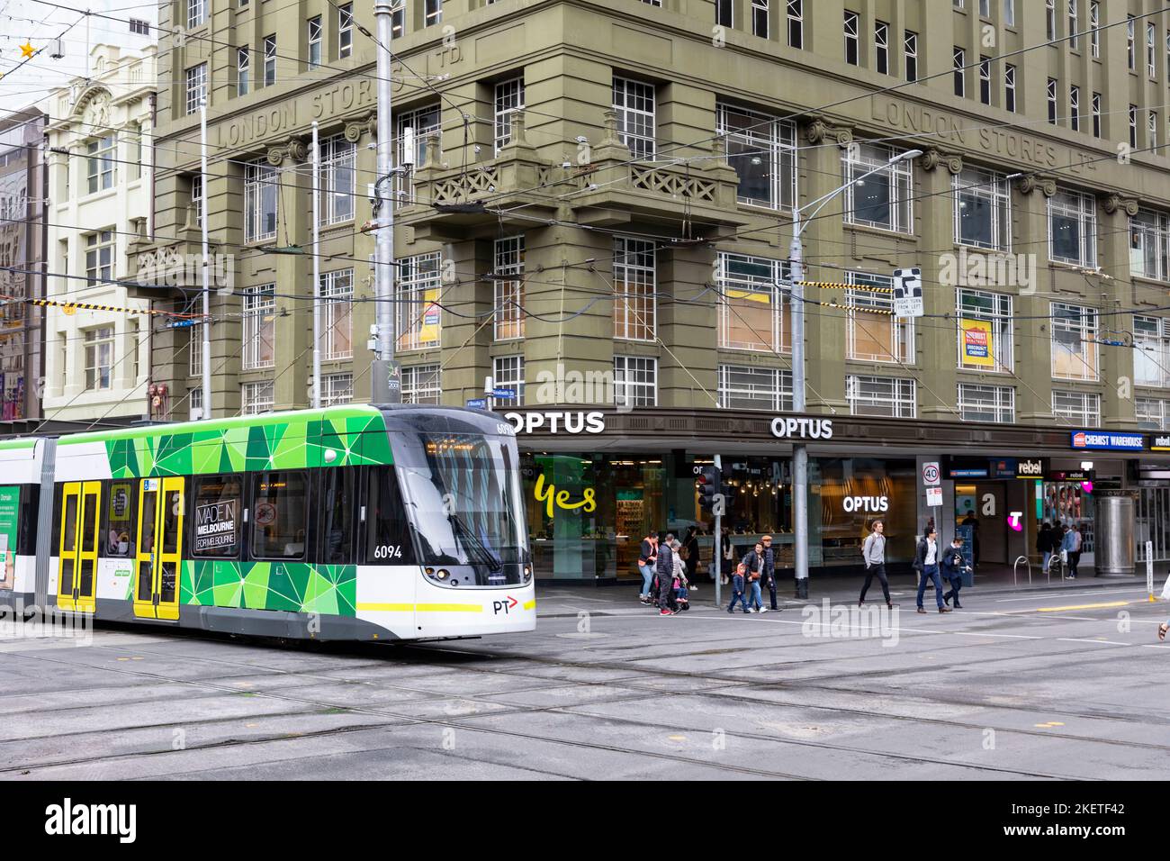Melbourne tram on Bourke street passes Optus telecommunications store ...