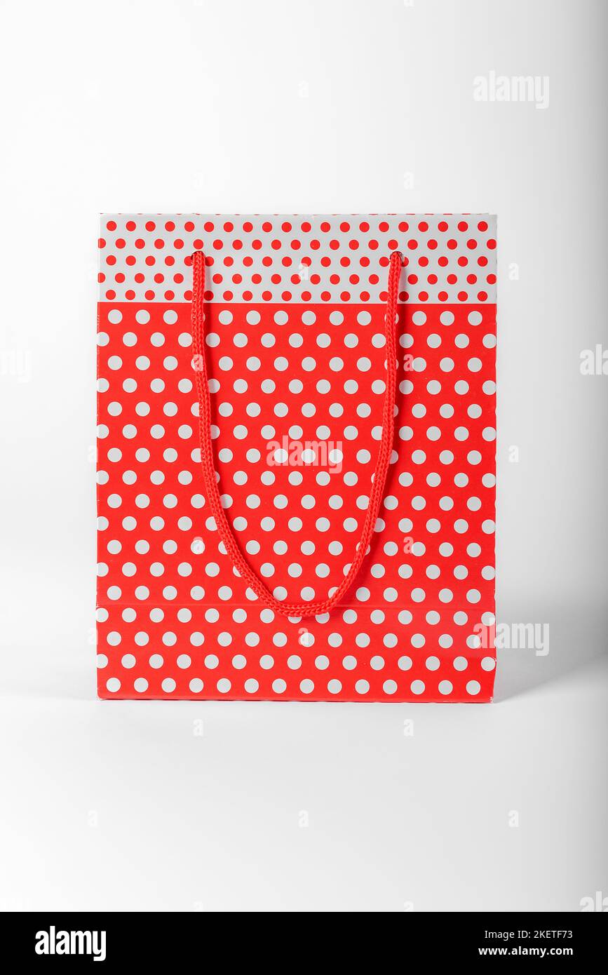 Bright red polka dot gift bag isolated on white background Stock Photo ...