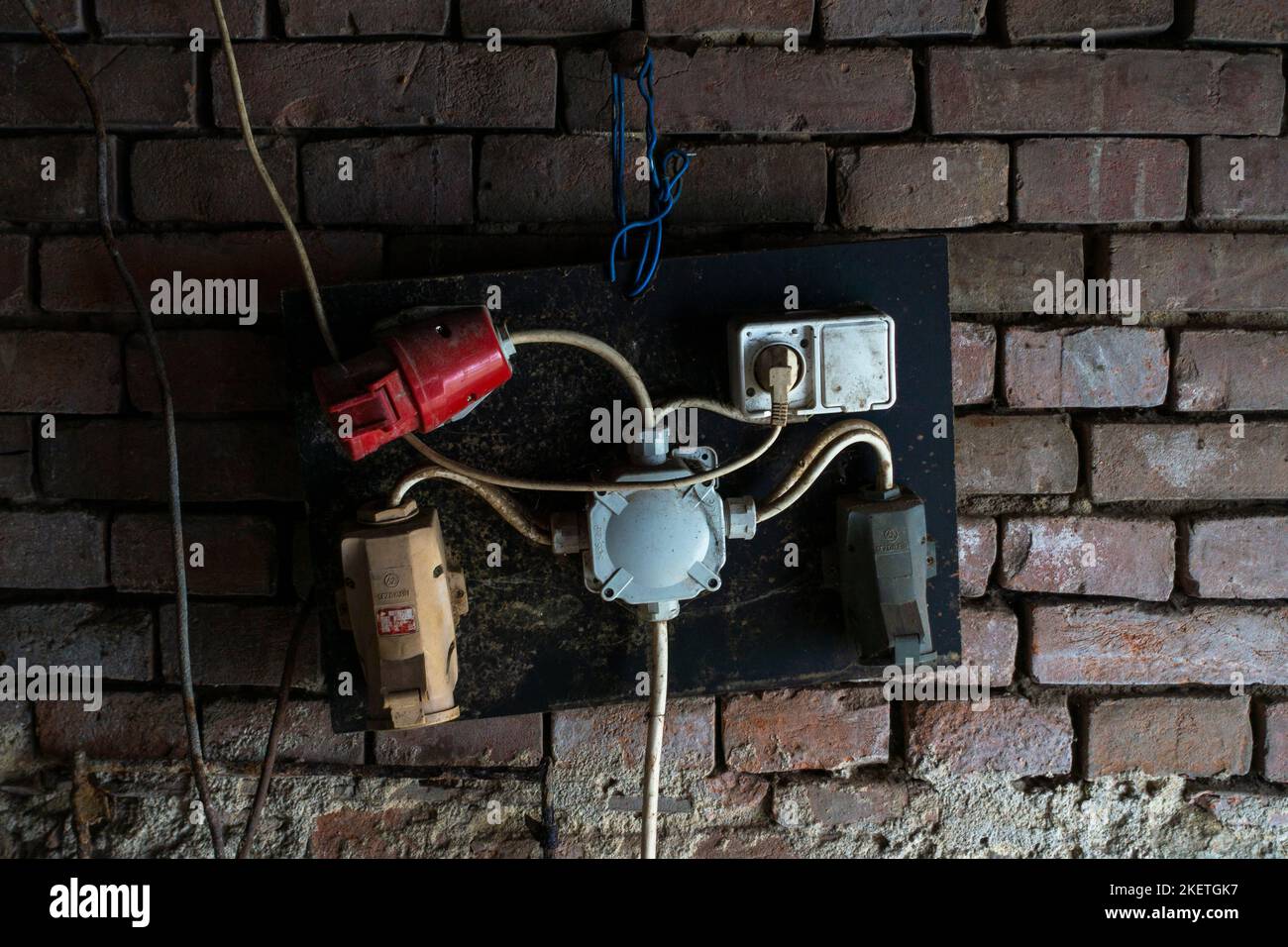 three phase socket, 3-phase, brick wall, dirty, dusty cellar, vault ...