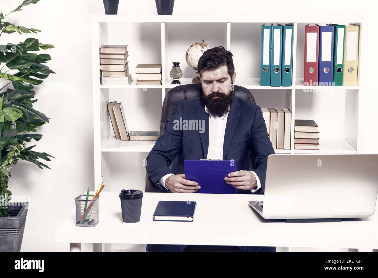 Check list. Man bearded hipster boss sit in leather armchair office ...
