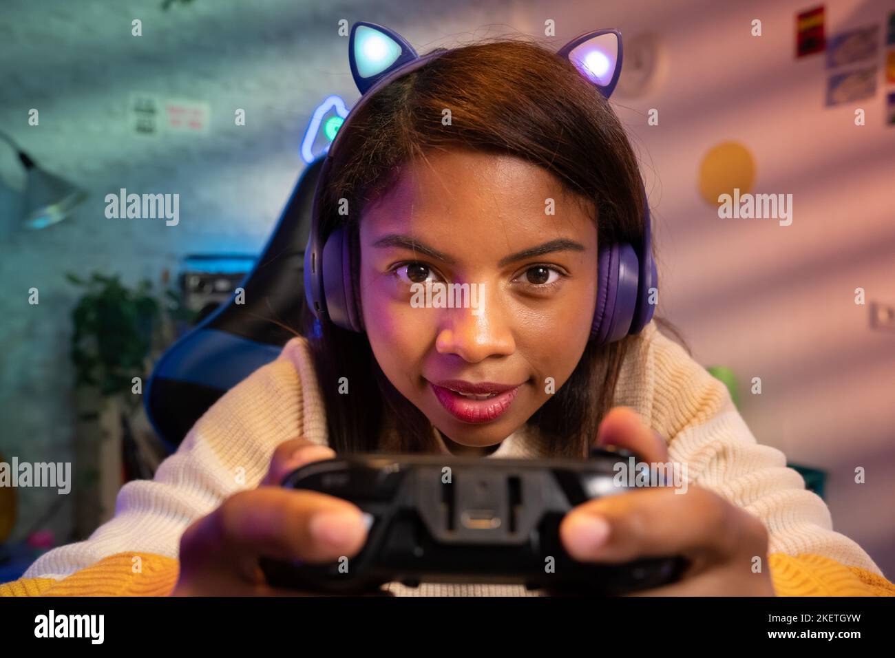 Happy latin female gamer playing video game streaming online with ...