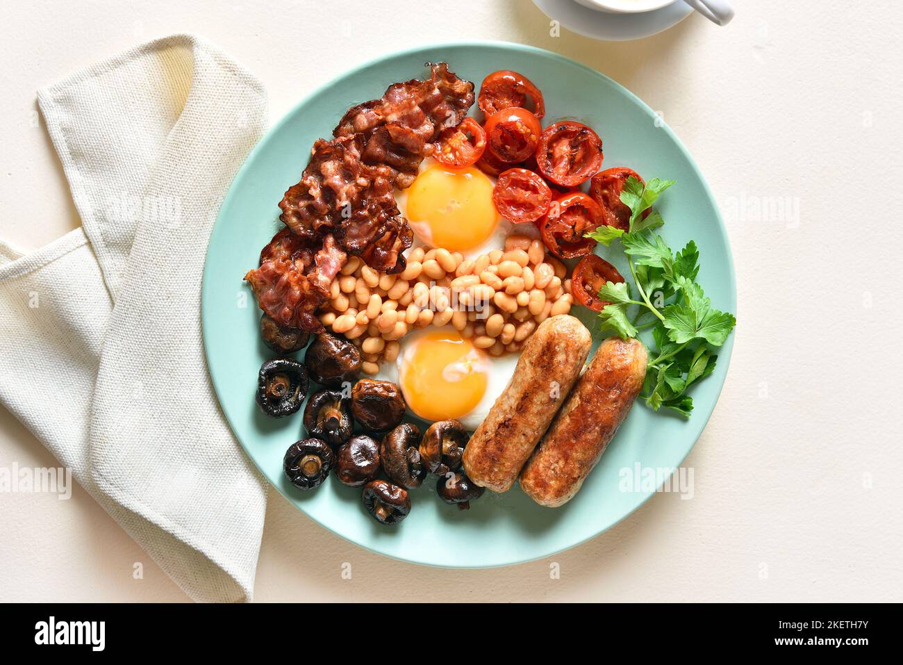 Full english breakfast with fried egg, bacon, sausage, beans and ...