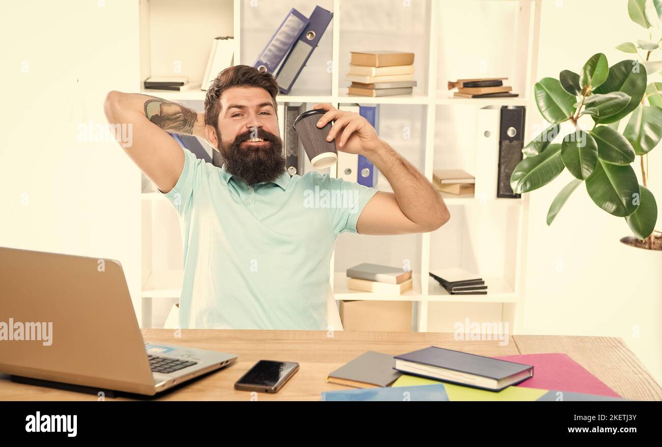 Happy businessman drinking coffee relaxing at office desk, break Stock ...