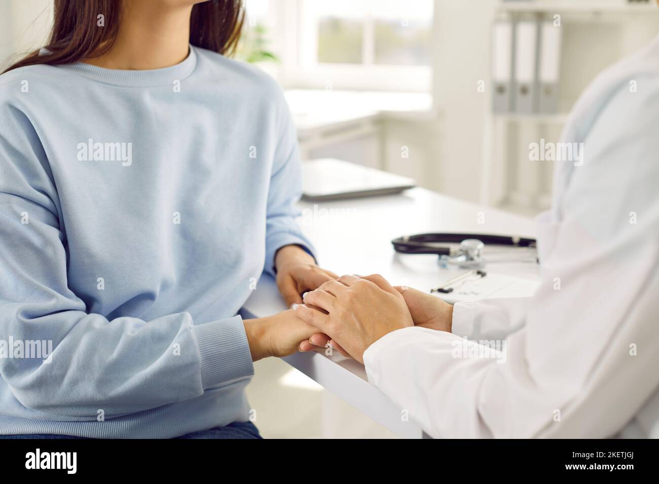 Caring woman doctor holding female patient and giving recommendations ...