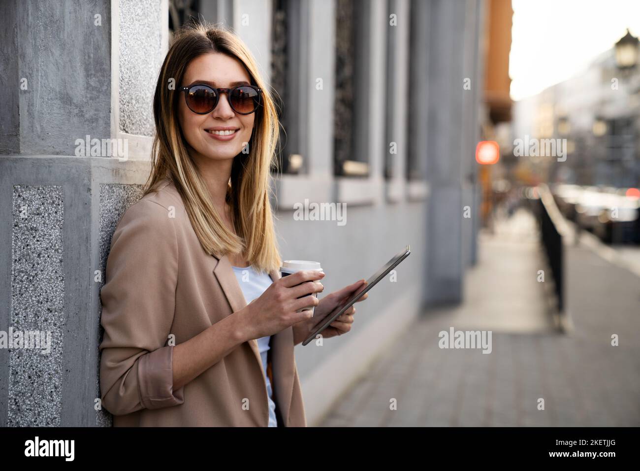 Portrait of a successful woman using digital tablet during quick break ...