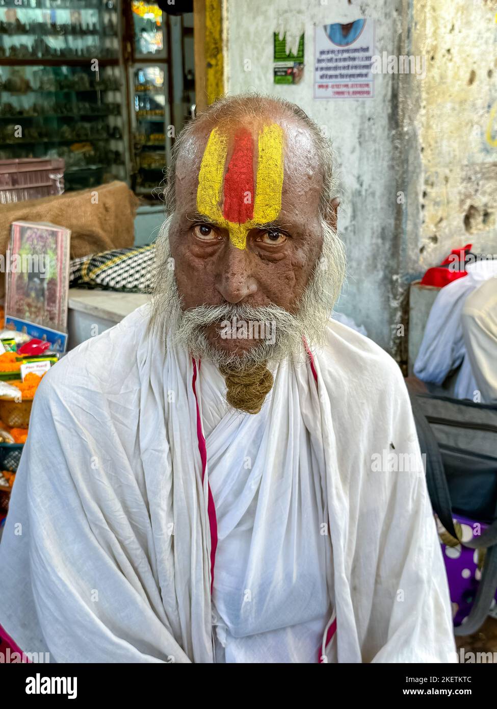 Pushkar, Rajasthan, India - November 2022: Portrait of an old sadhu baba on the street of ...