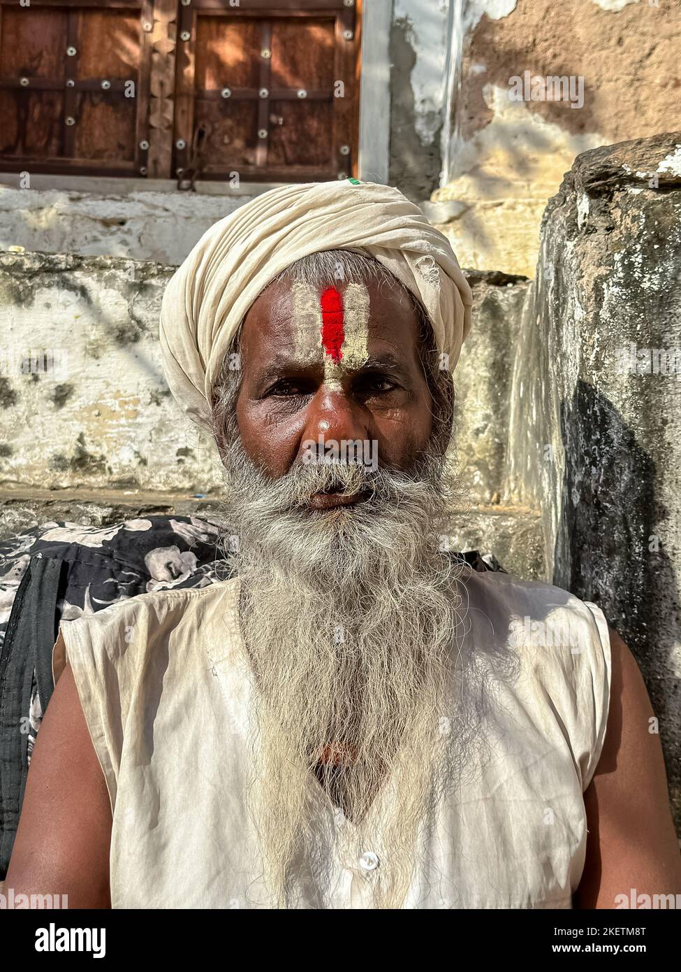 Pushkar, Rajasthan, India - November 2022: Portrait of an old sadhu baba on the street of ...