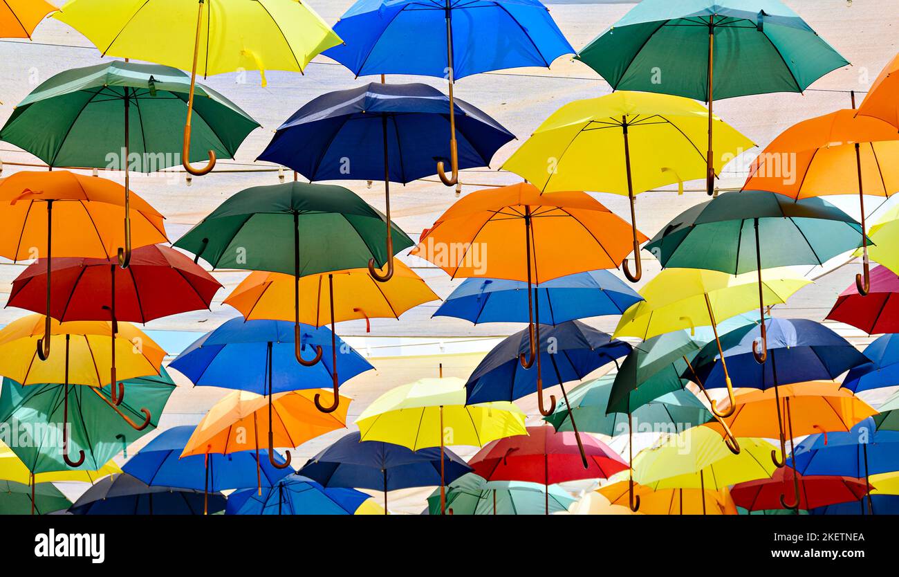 Background of many hanging colorful umbrellas decorating the street of ...