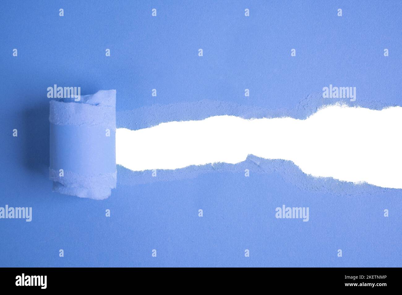 a torn blue sheet of paper that opens a window on a transparent ...