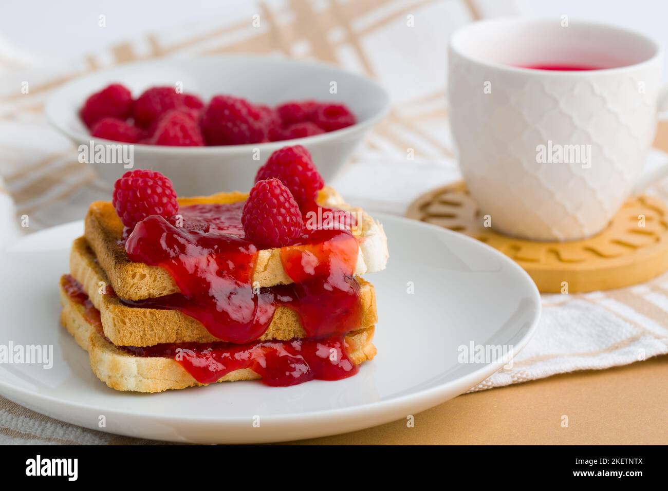 Toast with raspberry jam and cup of tea Stock Photo - Alamy