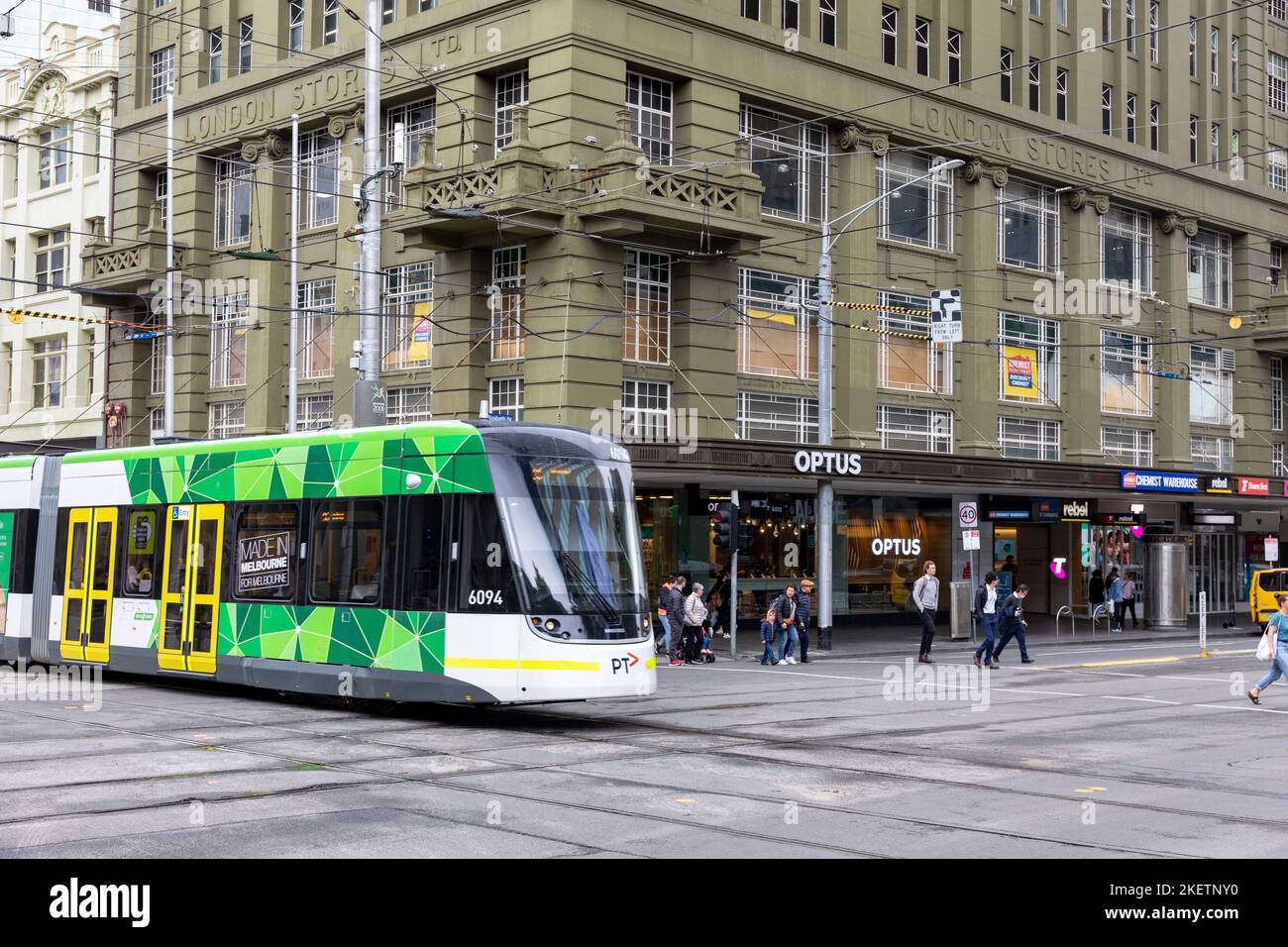 Melbourne tram in the city centre passes by Optus telecommunications ...