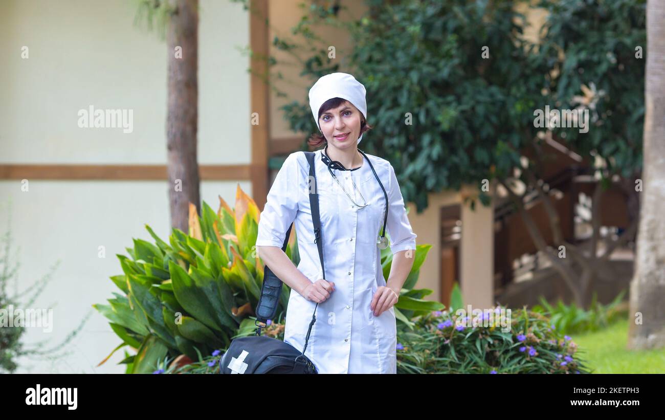 Nurse girl in a dressing gown, a hat and a bag on her shoulder Stock ...