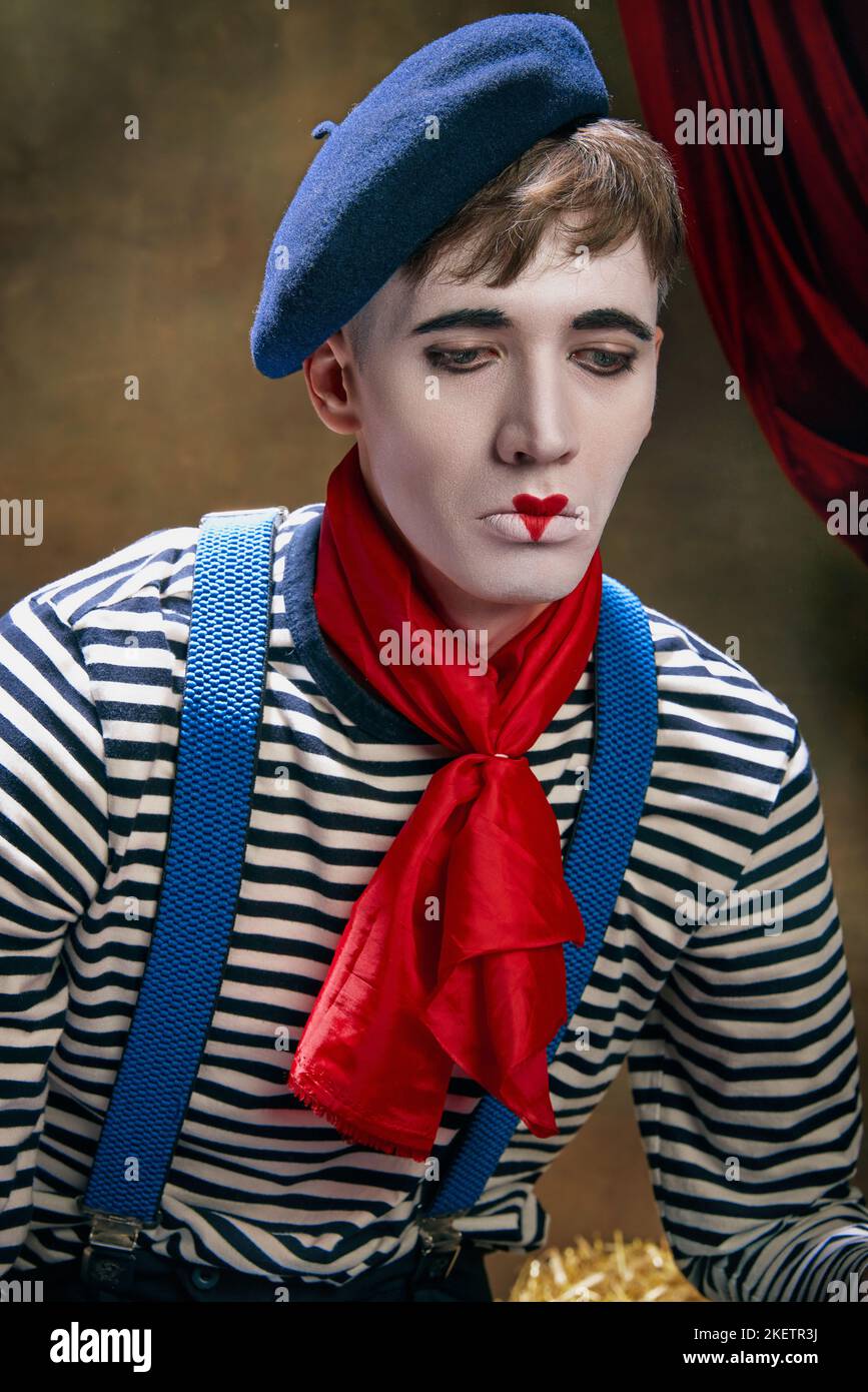 Closeup portrait of male mime artist expressing sadness and loneliness ...